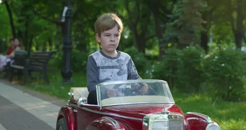 Cute Boy Drives Electric Red Car. Kid Ch... | Stock Video | Pond5
