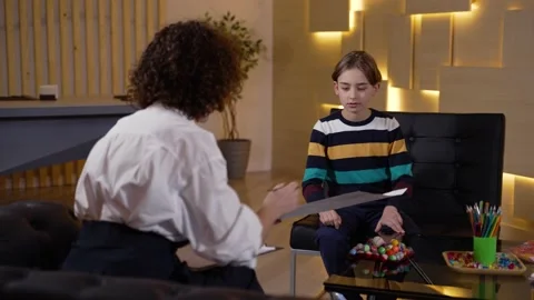 Cute boy explaining his drawing to child... | Stock Video | Pond5