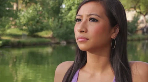 Cute Busty Asian Girl Sitting by Water o... | Stock Video | Pond5