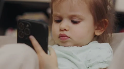 Cute caucasian baby girl sitting on sofa... | Stock Video | Pond5