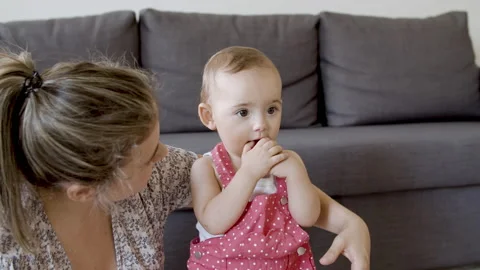 Cute cheerful little girl biting her fin... | Stock Video | Pond5