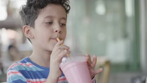 Cute Child Boy Drinking Milkshake with P... | Stock Video | Pond5
