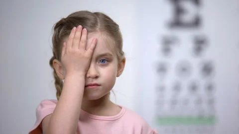 Cute child closing one eye to test visua... | Stock Video | Pond5