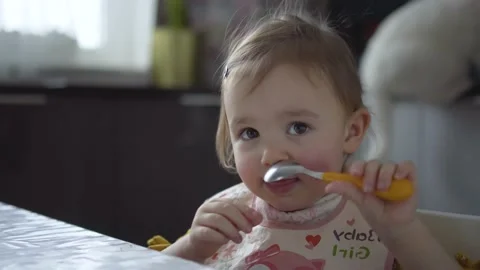 Cute child eating. Baby girl eating heal... | Stock Video | Pond5