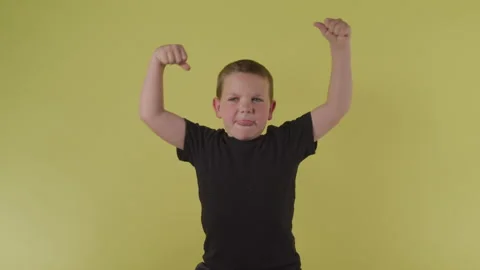 Cute Child Flexing His Muscles in Front ... | Stock Video | Pond5