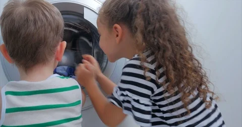 Cute Children Looks Inside the Washing M... | Stock Video | Pond5