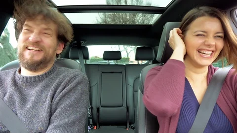 Cute couple in love laughing driving car... | Stock Video | Pond5