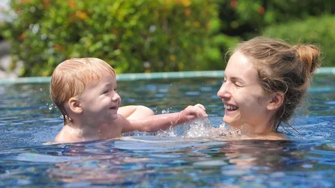Cute funny baby learning to swim with hi... | Stock Video | Pond5