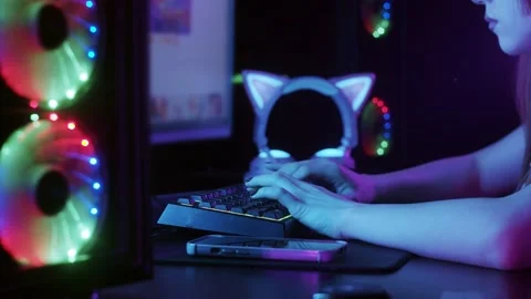 Cute gamer girl sitting by PC illuminate... | Stock Video | Pond5
