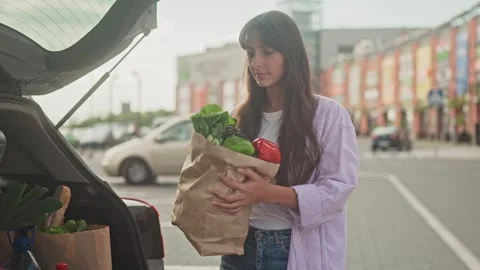 Cute girl carries paper bag with vegetab... | Stock Video | Pond5