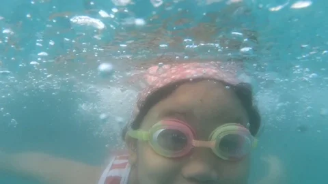 Cute girl diving under the water in the ... | Stock Video | Pond5