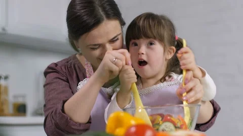Cute girl with down syndrome cooking wit... | Stock Video | Pond5