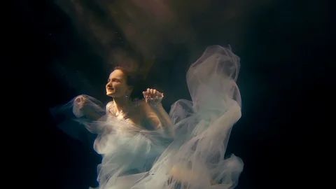 cute girl is floating at the depth of th... | Stock Video | Pond5