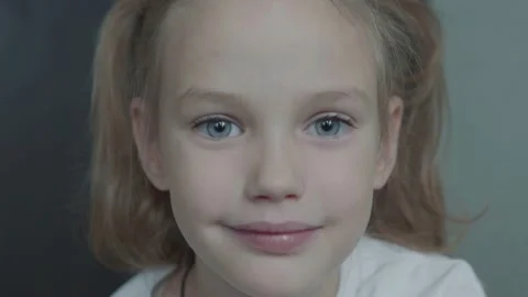 Cute girl kid looking at camera. Portrai... | Stock Video | Pond5