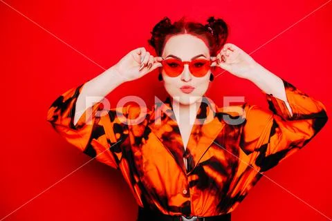 Cute girl on a red background. Red hair and tunnels in the ears, red ...