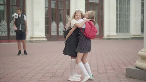 Cute girl running and hugging classmate ... | Stock Video | Pond5