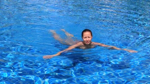 Cute girl swim in the swimming pool | Stock Video | Pond5
