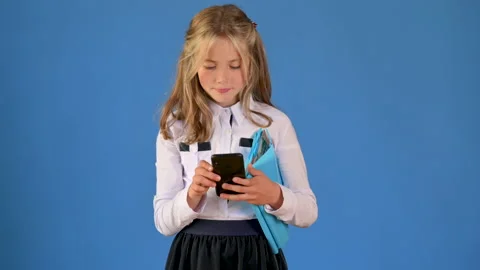 Cute girl is typing text on the phone on... | Stock Video | Pond5