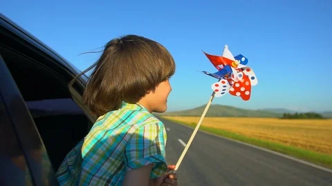 Cute happy boy child leaned out, looking... | Stock Video | Pond5