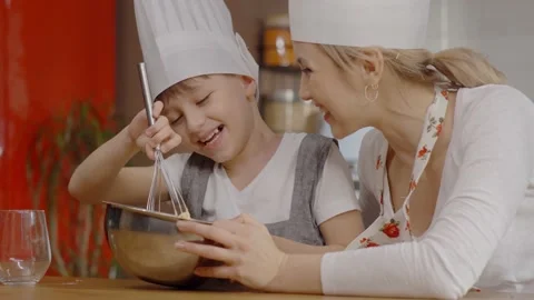 Cute kid boy learning to cook with lovin... | Stock Video | Pond5