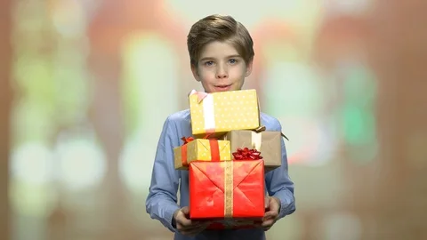 Cute kid holding stack of gift boxes. | Stock Video | Pond5