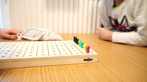 Cute Kids playing wooden Mastermind game... | Stock Video | Pond5