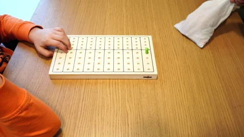 Cute Kids playing wooden Mastermind game... | Stock Video | Pond5