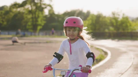 Cute light hair little girl in pink helm... | Stock Video | Pond5