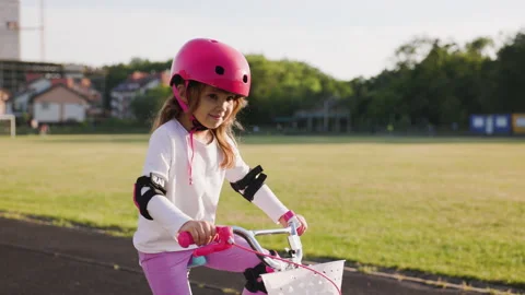 Cute light hair little girl in pink helm... | Stock Video | Pond5