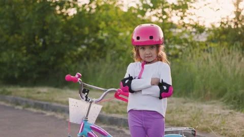 Cute light hair little girl in pink helm... | Stock Video | Pond5