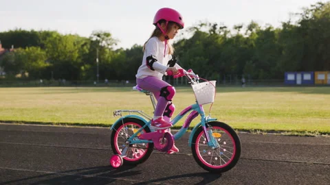 Cute light hair little girl in pink helm... | Stock Video | Pond5