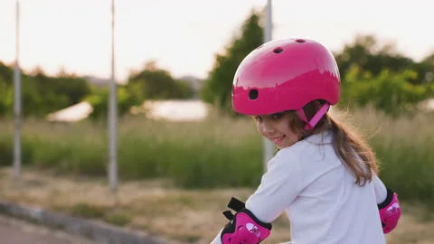 Cute light hair little girl in pink helm... | Stock Video | Pond5