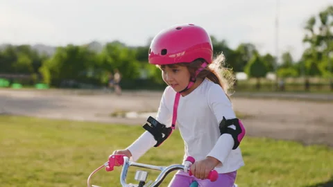Cute light hair little girl in pink helm... | Stock Video | Pond5