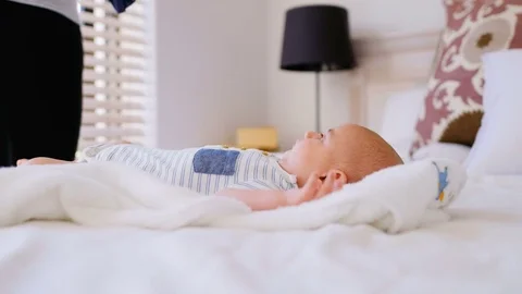 Cute little baby getting dressed by moth... | Stock Video | Pond5