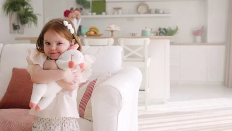 cute little baby girl hugging soft unico... | Stock Video | Pond5