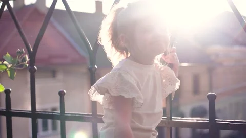cute little baby girl in sun rays having... | Stock Video | Pond5