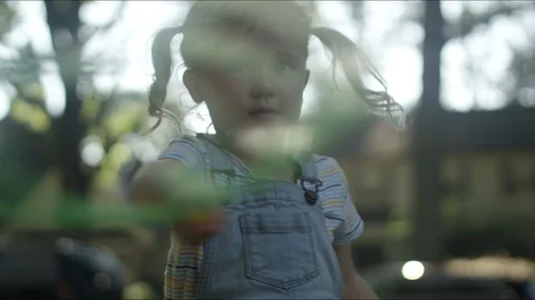 A cute little blonde girl waves a bubble... | Stock Video | Pond5