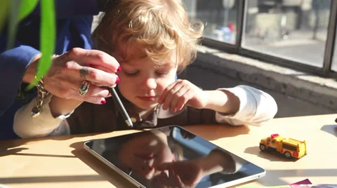 A cute little boy is being taught how to... | Stock Video | Pond5