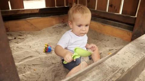 Cute little boy digging sand with toy sh... | Stock Video | Pond5