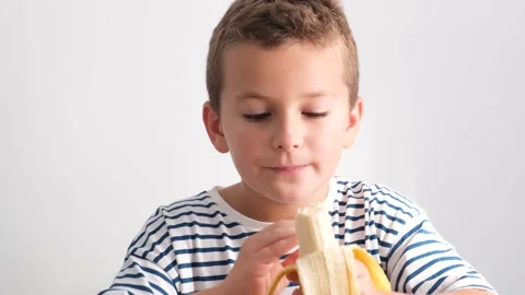 A cute little boy eats a delicious ripe ... | Stock Video | Pond5