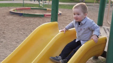 Cute little boy moving down from childre... | Stock Video | Pond5