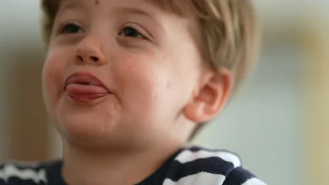 Cute little boy spitting to camera stick... | Stock Video | Pond5