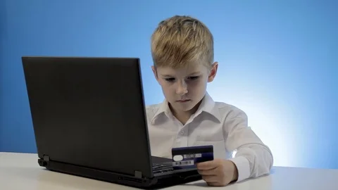 Cute little boy use laptop and credit ca... | Stock Video | Pond5