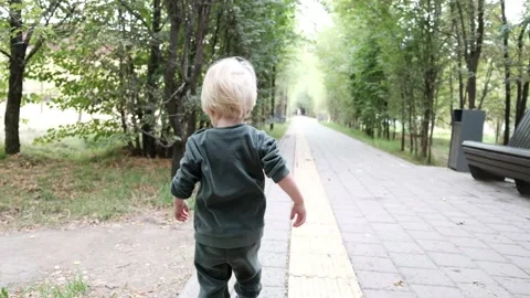 cute little boy walking on the path in t... | Stock Video | Pond5