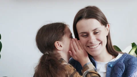 Cute little daughter telling secret to s... | Stock Video | Pond5