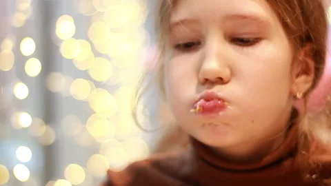 Cute little girl bites a croissant with ... | Stock Video | Pond5