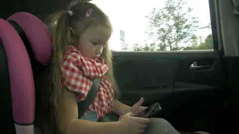 Cute little girl busy with smart phone w... | Stock Video | Pond5