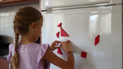 Cute little girl connecting triangles of... | Stock Video | Pond5