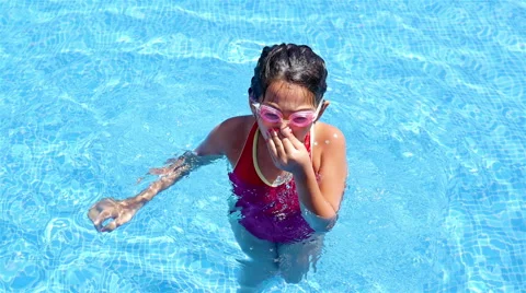 Cute little girl dunking head in a pool | Stock Video | Pond5