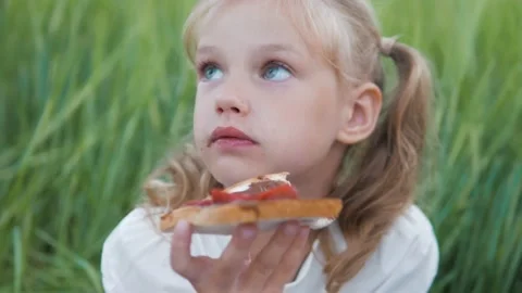 Cute little girl eating chewing chocolat... | Stock Video | Pond5